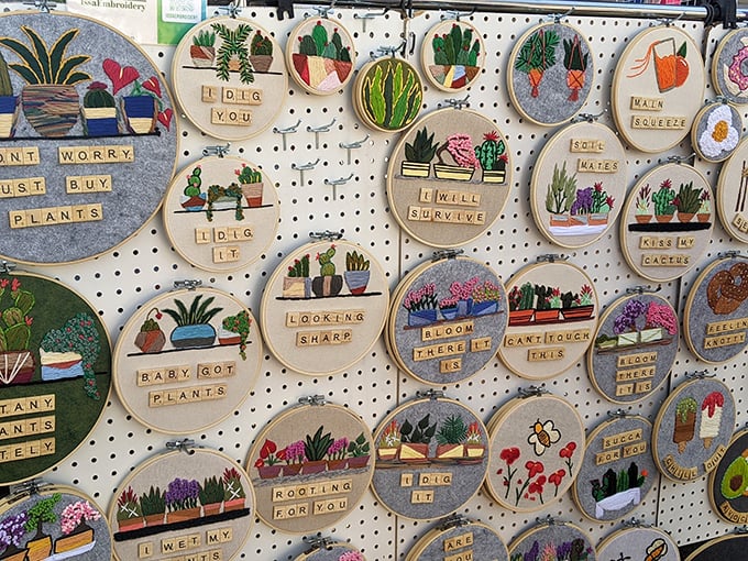 Embroidery hoops transformed into tiny botanical worlds, complete with clever wordplay. "Don't worry, just buy plants" might be the best advice ever stitched.