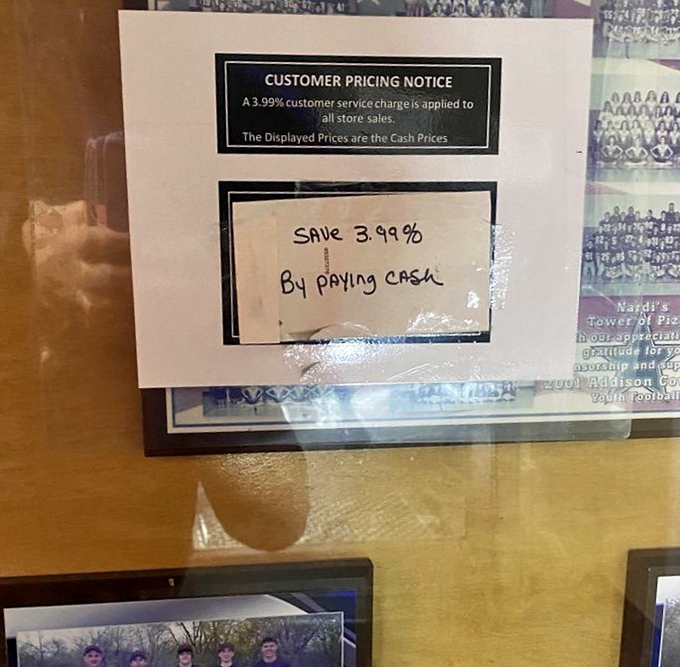 Old-school cash discount notice that reminds you this place is about substance over style. Pizza economics 101.