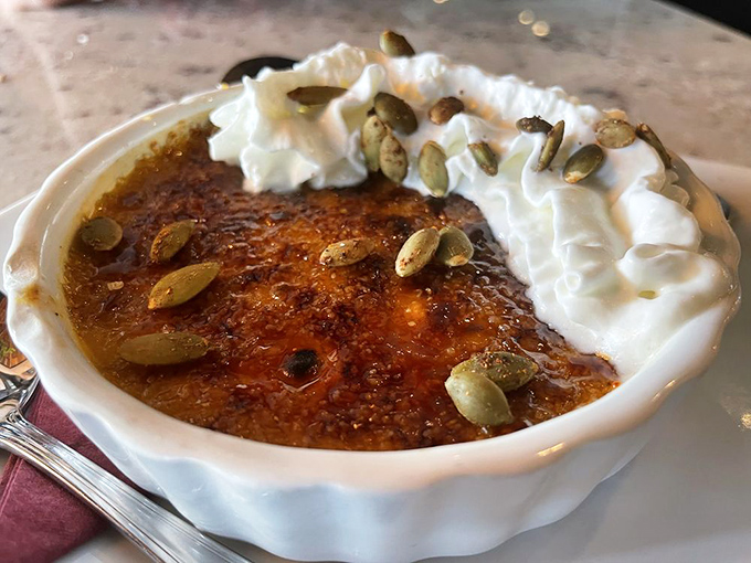 This cr&egrave;me br&ucirc;l&eacute;e isn't just dessert &ndash; it's a golden-topped treasure chest with a perfectly crackable surface that satisfies your inner child and sophisticated adult simultaneously.
