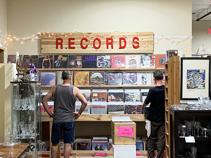 Two vinyl enthusiasts contemplating life's important questions: Beatles or Stones? Original pressing or reissue? Will my spouse notice another record purchase?