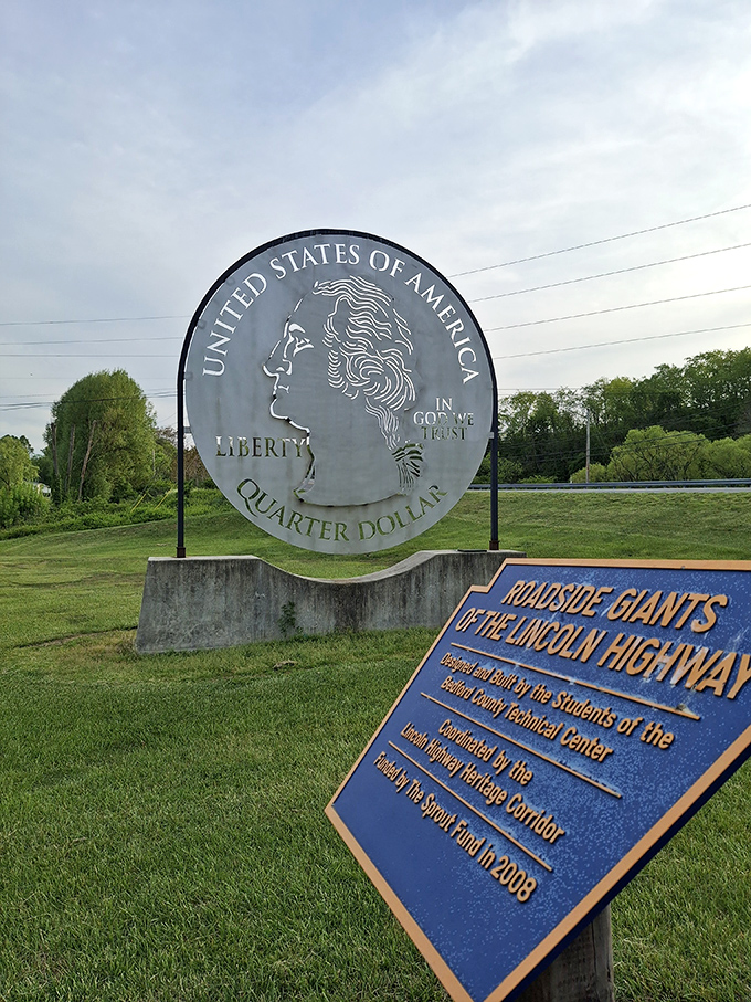 The informational sign adds context to the quirky landmark. Part of the "Roadside Giants" project, this quarter has been turning heads since 2008.