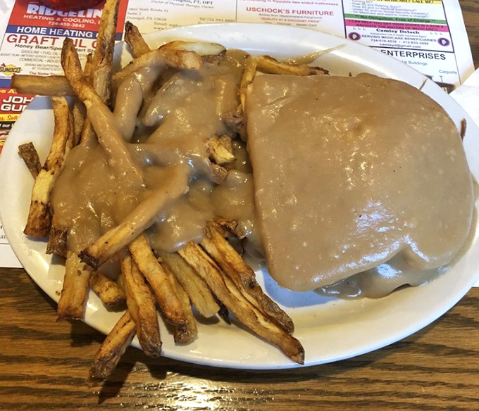 Hot roast beef sandwich where the gravy-to-meat ratio achieves that perfect mathematical equation only small-town diners truly understand.