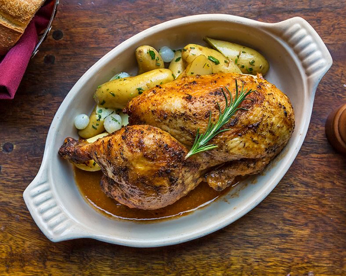 A roasted chicken that proves simplicity is the ultimate sophistication. Those potatoes soaking up the jus are having the time of their lives.