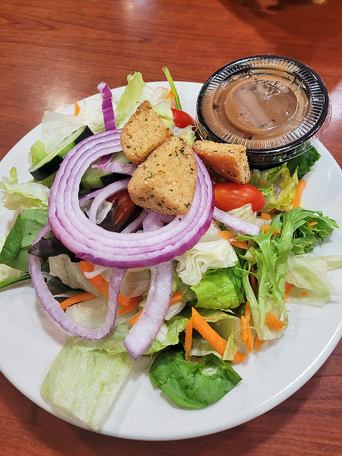 A garden on a plate that somehow makes virtue feel indulgent. Those purple onion rings are practically jewelry for your salad.