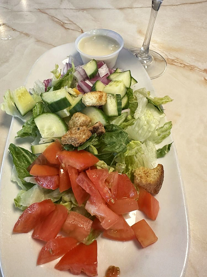 A garden-fresh salad that proves healthy options can coexist peacefully with milkshakes in the diner universe&mdash;balance achieved.