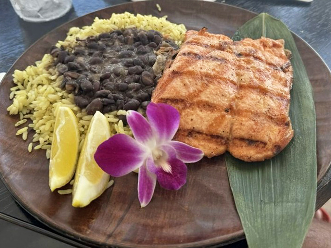 Grilled salmon perfection accompanied by sides that complement rather than compete &ndash; culinary teamwork at its finest level.
