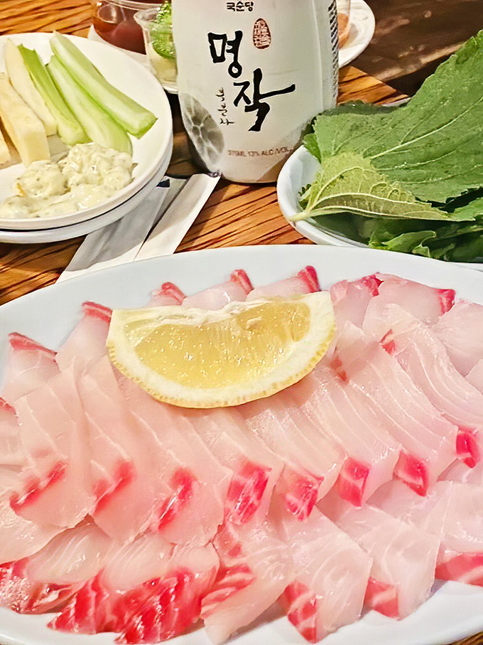 Fresh sashimi that tastes like the ocean just hand-delivered it to your table. That lemon wedge isn't just garnish &ndash; it's the perfect supporting actor.