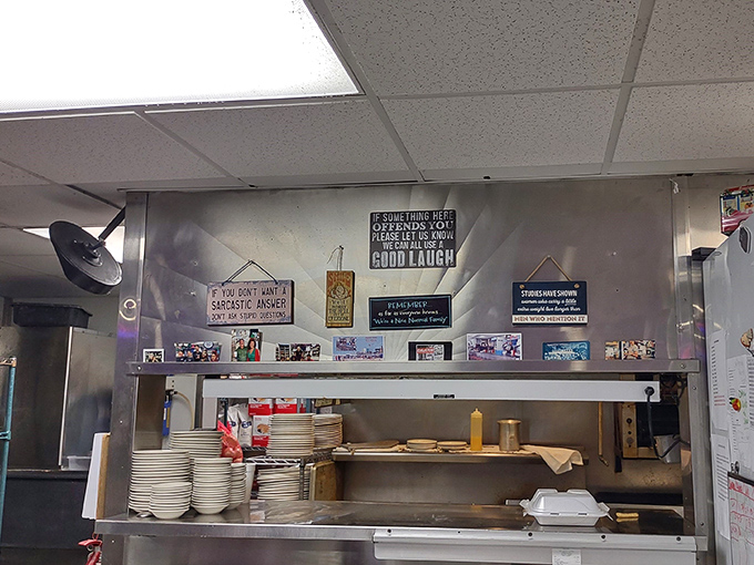 The kitchen pass reveals the diner's philosophy in posted signs: "If something here offends you, please feel free to have a good laugh."