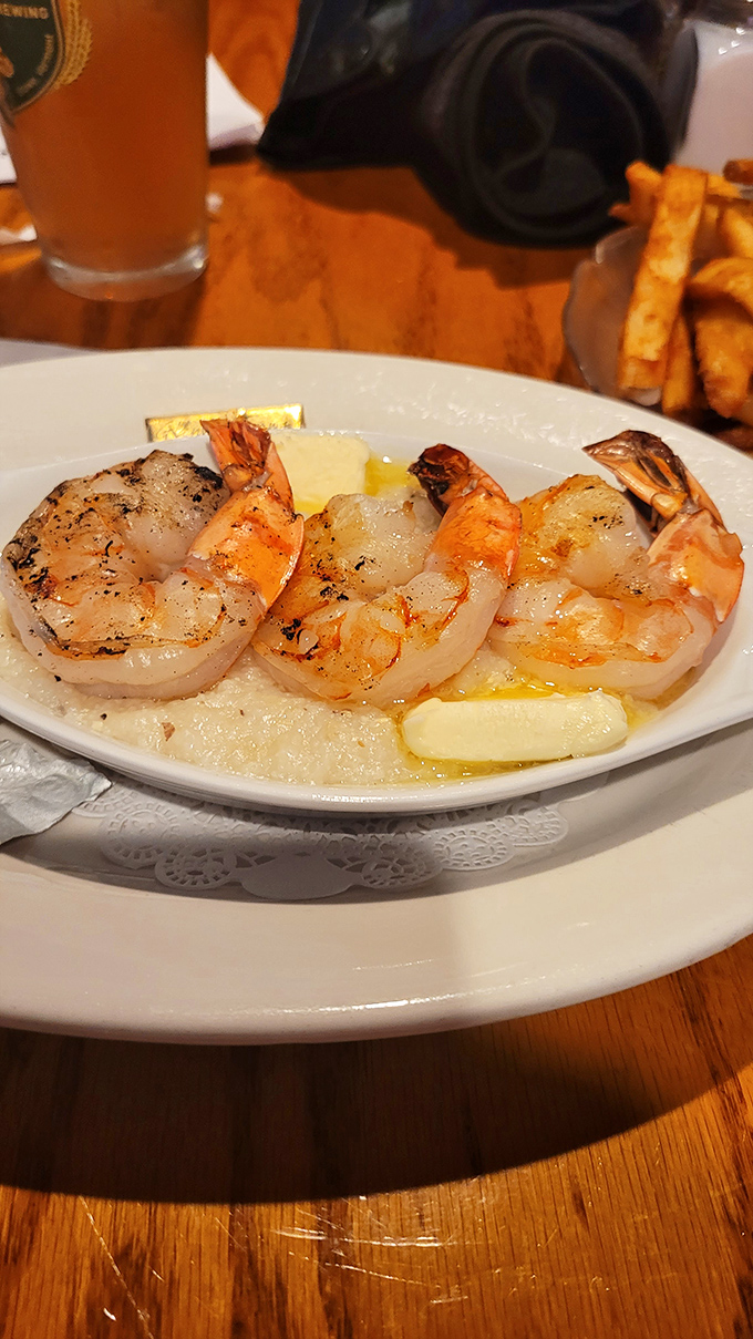 Plump, perfectly grilled shrimp resting in a buttery pool &ndash; proof that sometimes the simplest preparations create the most profound flavors.