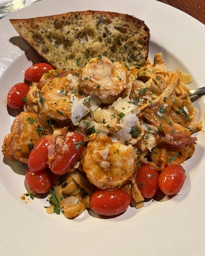 Shrimp pasta that's having a party with cherry tomatoes and fresh herbs. Your fork is definitely invited to this celebration.