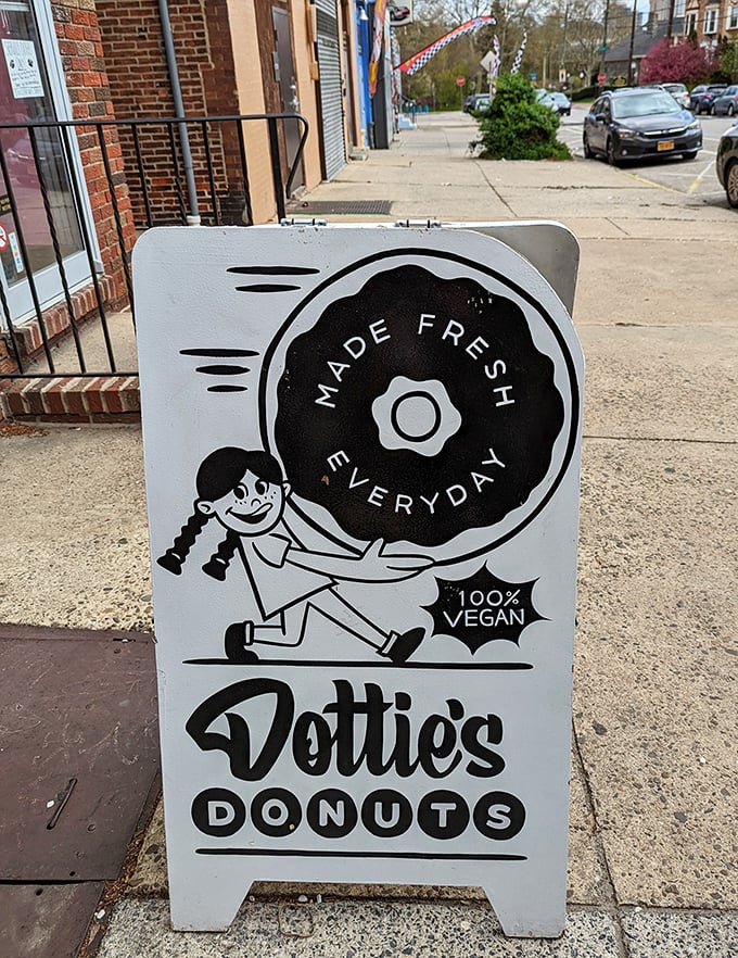 The sidewalk sign proudly announces "100% VEGAN" with vintage charm, inviting passersby into a world where no animals were harmed in the making of deliciousness.