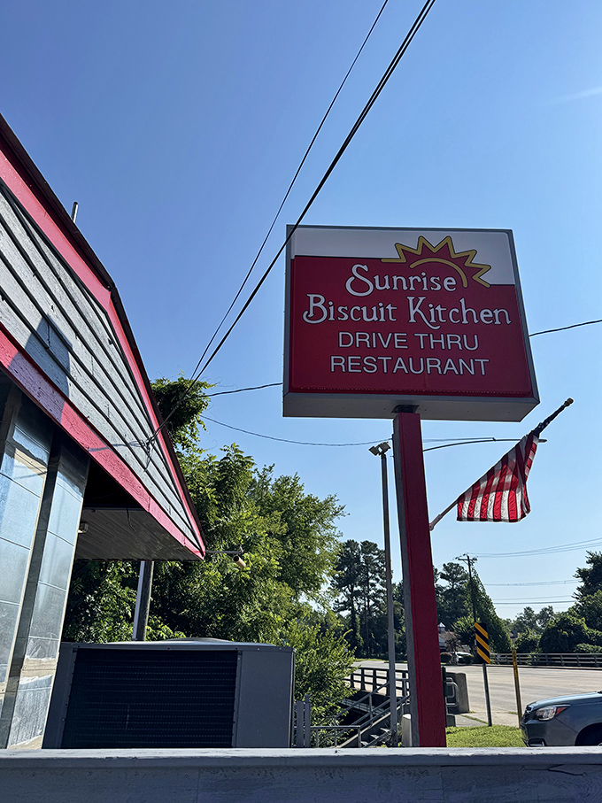 Morning sunshine and an American flag frame the classic Sunrise Biscuit Kitchen sign &ndash; a patriotic tribute to one of America's truly perfect breakfast institutions.
