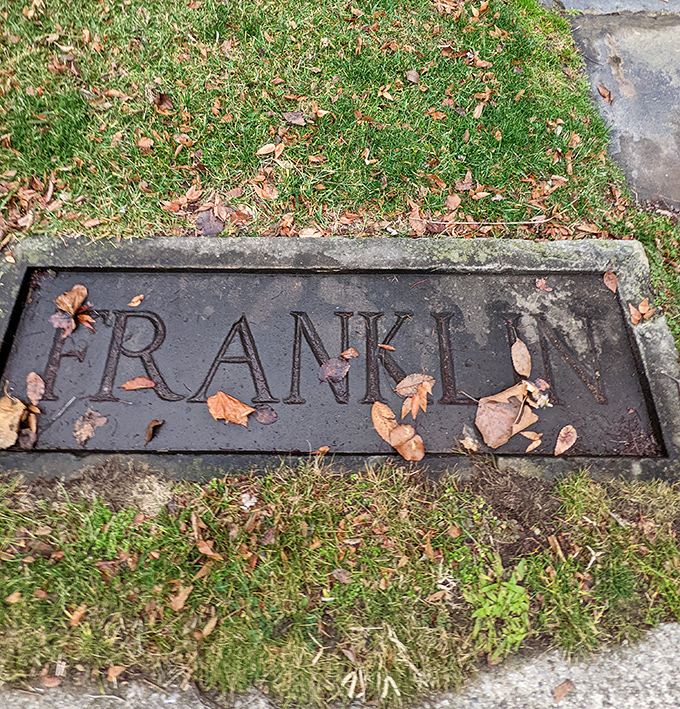 A simple stone marker bearing the "Franklin" name &ndash; a humble contrast to the architectural extravagance that stands nearby.