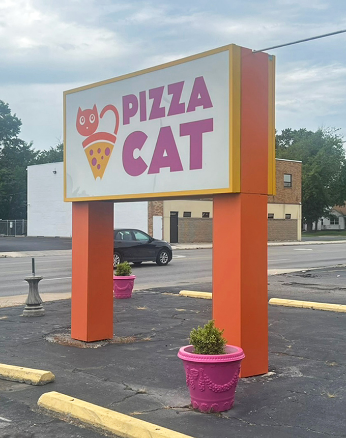 The Pizza Cat sign stands tall and proud, featuring a cartoon cat perched on a pizza slice&mdash;a whimsical promise of the feline-level curiosity about flavors waiting inside.