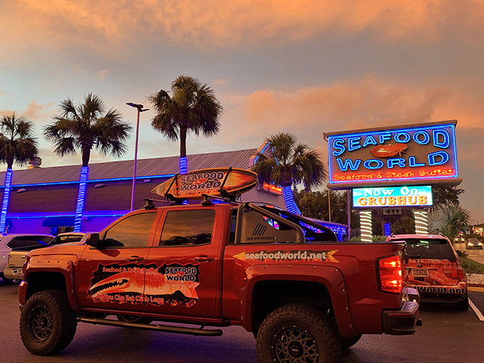 As dusk falls, the neon glow of Seafood World beckons like a lighthouse for the hungry, promising oceanic delights within.