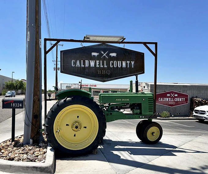A vintage John Deere tractor and rustic signage announce your arrival at meat paradise – farm-to-table in the most literal sense.