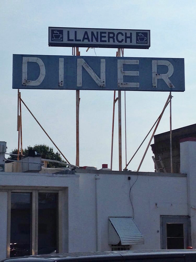 The Llanerch sign stands tall against the Pennsylvania sky, a blue beacon promising good food and better memories below.