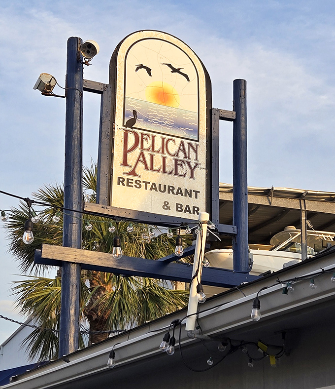 The sign says it all&mdash;pelicans, sunset, and promises of good food. This weathered wooden welcome has guided hungry travelers for years.