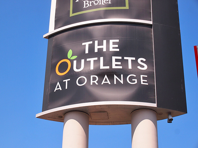 The iconic Outlets at Orange sign stands tall against the blue California sky, a monument to retail therapy and fiscal responsibility.