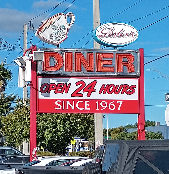The roadside sign promises what Florida travelers need most: reliability, comfort, and pancakes available at absolutely any hour of the day or night.