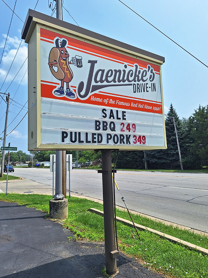 The iconic sign with its hot dog mascot stands as a cheerful sentinel, guiding hungry travelers to this temple of comfort food.