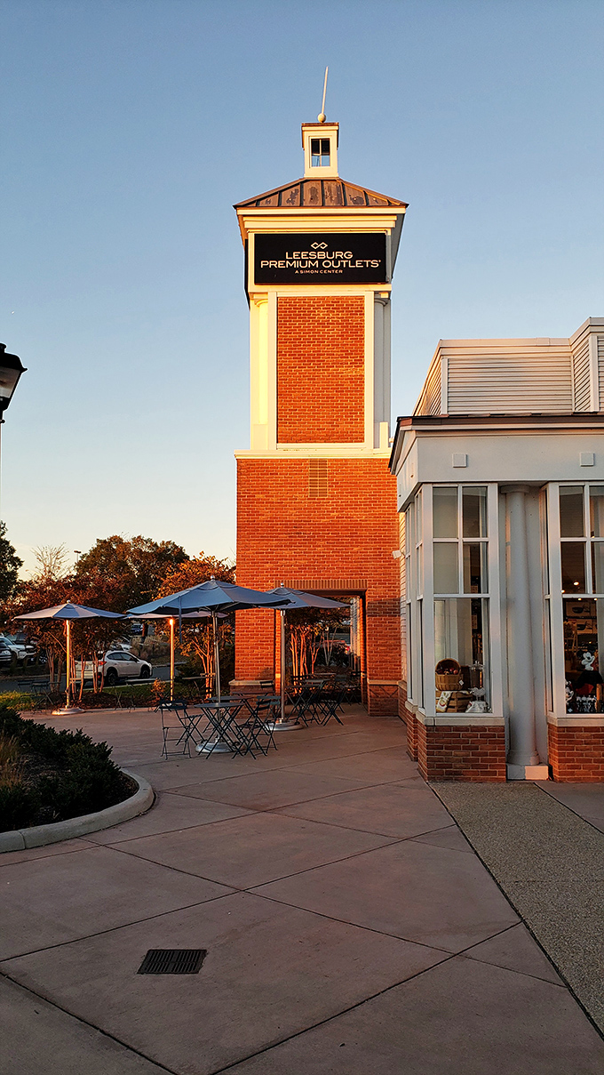The iconic Leesburg Premium Outlets tower stands sentinel against the evening sky. A beacon of bargains that's become a landmark for savvy shoppers.