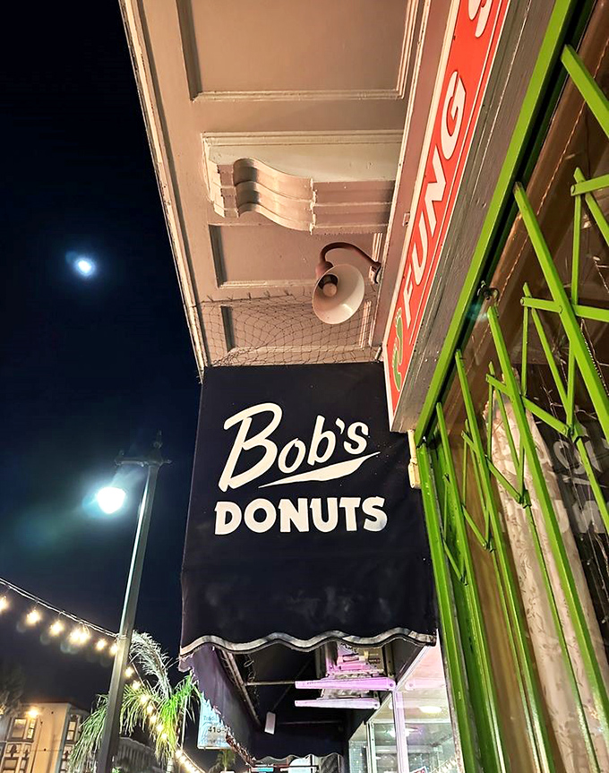 Under moonlight, Bob's sign glows like a beacon for night owls and early risers alike &ndash; a 24-hour promise of deep-fried happiness.