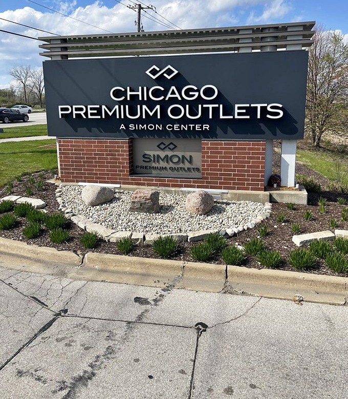 The entrance sign stands like a retail promised land marker. "Chicago Premium Outlets" translates roughly to "prepare your credit card for exercise."