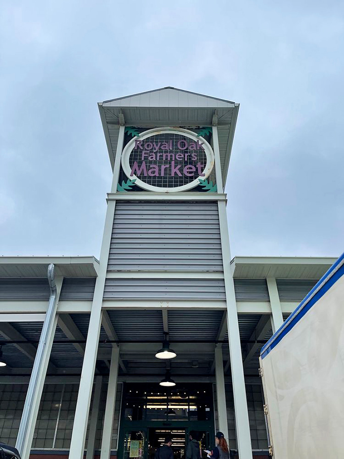 The Royal Oak Farmers Market sign towers above, a beacon for those seeking community, craftsmanship, and the occasional impulse purchase they'll cherish forever.