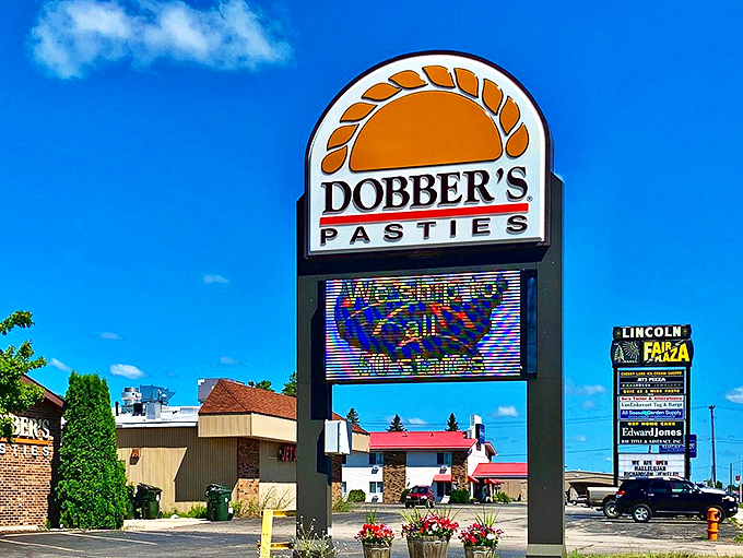 The iconic Dobber's sign stands tall against the Michigan sky, a landmark for hungry travelers seeking authentic U.P. cuisine.
