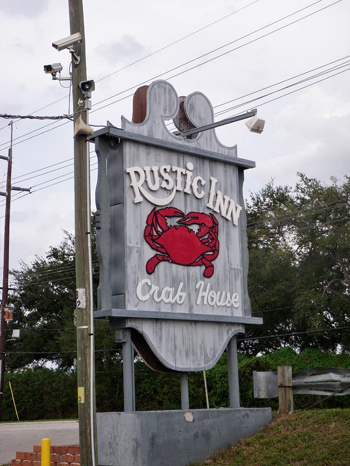 The roadside sign stands like a beacon to hungry travelers&mdash;that red crab silhouette promising seafood salvation just around the corner.
