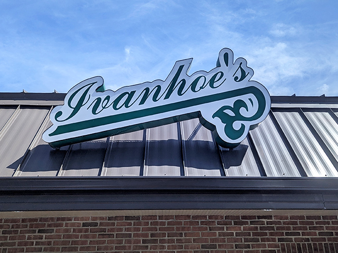 The iconic Ivanhoes sign beckons like a green lighthouse guiding hungry travelers to safe harbor where ice cream flows and smiles are guaranteed.