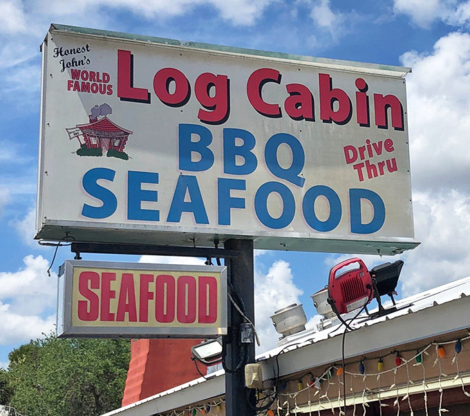The sign promises both BBQ and seafood, but that cartoon pig knows what you're really here for—smoky, slow-cooked meat that's worth the drive.