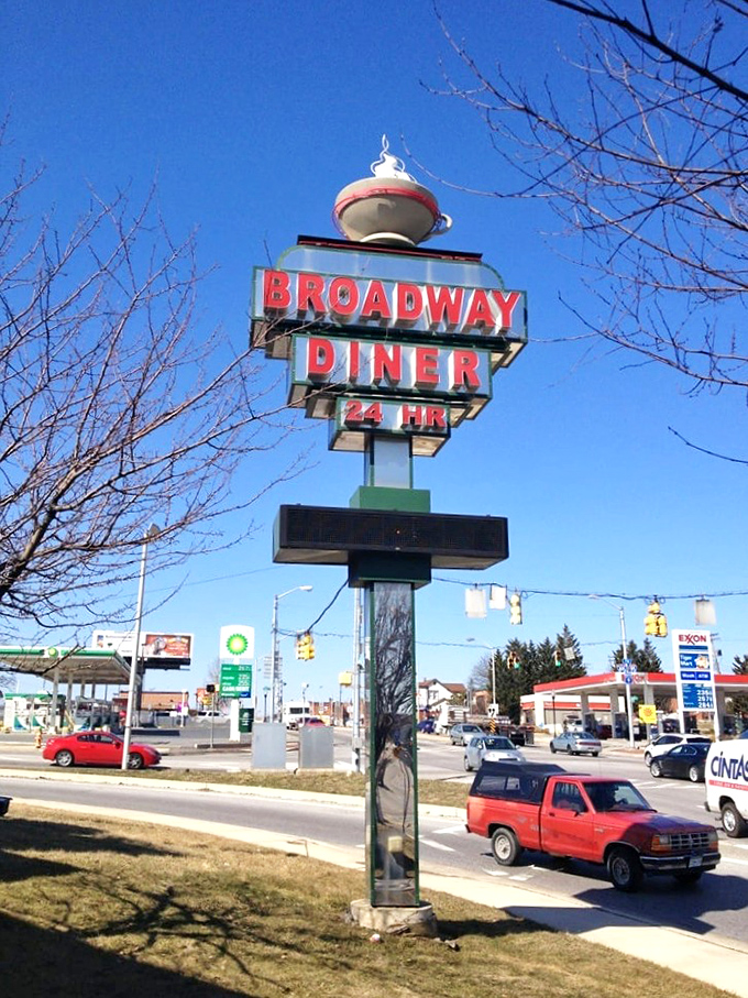 The roadside sign stands tall against the Maryland sky, a retro landmark announcing "24 HRS" because hunger doesn't keep regular business hours.
