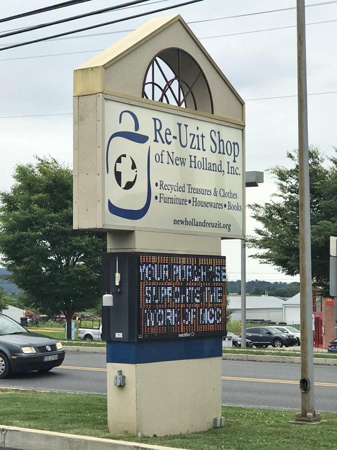 The beacon of bargains! Re-Uzit Shop's sign stands proudly along the roadside, guiding thrifty shoppers to their secondhand sanctuary.