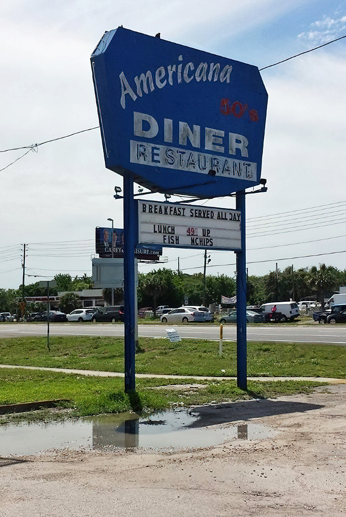 The iconic blue sign stands as a beacon for hungry travelers, promising "Breakfast Served All Day" &ndash; four words that spell comfort.