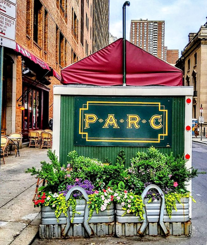 The Parc sign, surrounded by flowers, stands as a beacon for hungry Philadelphians seeking their French fix.