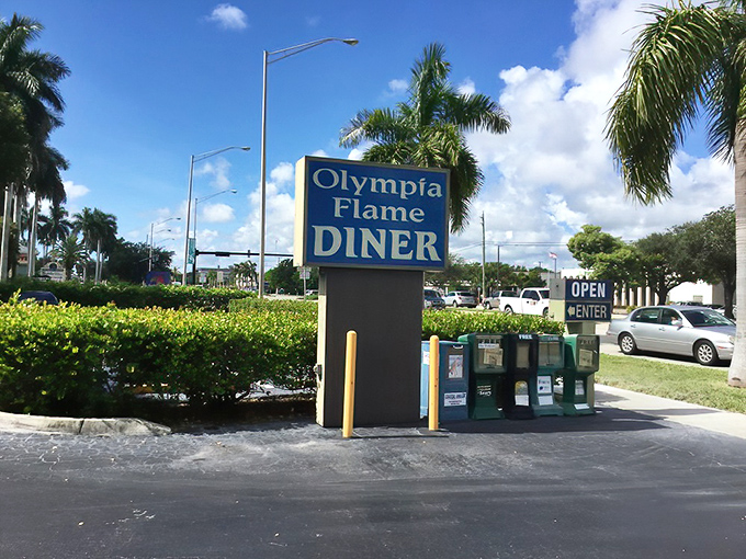 The roadside sign stands proud against Florida's blue sky, guiding hungry travelers to their delicious destination like a culinary lighthouse.