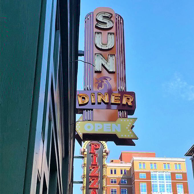 The retro neon sign beckons hungry passersby like a beacon of breakfast hope&mdash;a glowing promise of comfort food and musical nostalgia.