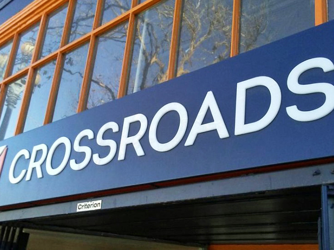 The bold CROSSROADS signage announces itself with confidence, like a fashion-forward friend who always knows where to find the good stuff.