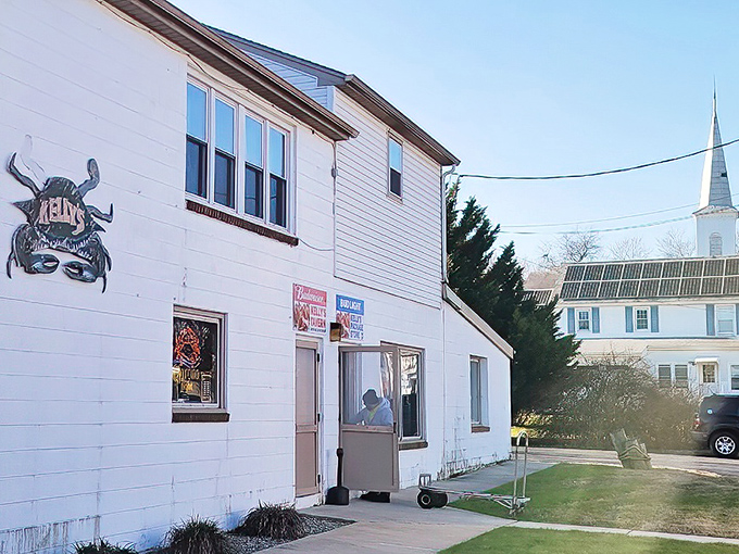 Kelly's Tavern stands proudly in Port Penn, its crab logo a beacon to seafood lovers, with a church steeple neighbor that's seen generations come for crab cake salvation.