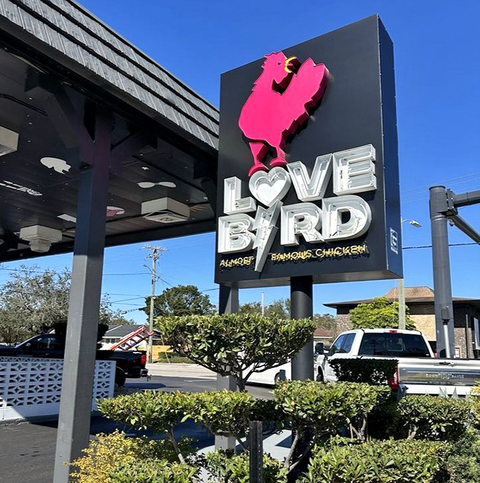 The pink chicken silhouette on the LoveBird sign stands proud against the blue Florida sky &ndash; a monument to poultry perfection in Lakeland. 