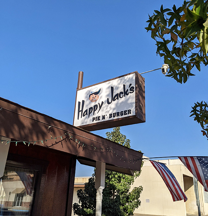 The iconic sign stands against the blue California sky, a beacon of burger hope for those in the know and a promise of satisfaction for first-timers.