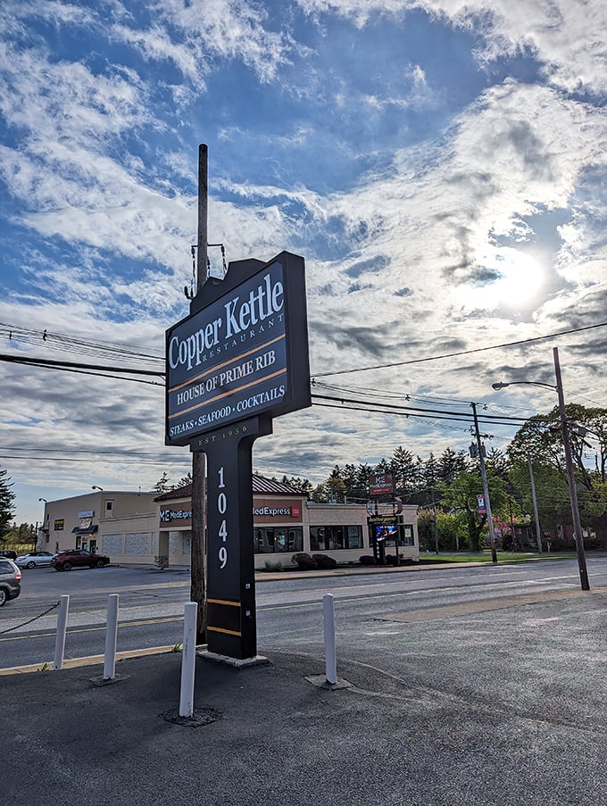 The sign stands tall against dramatic clouds, marking your destination for those legendary stuffed mushrooms.