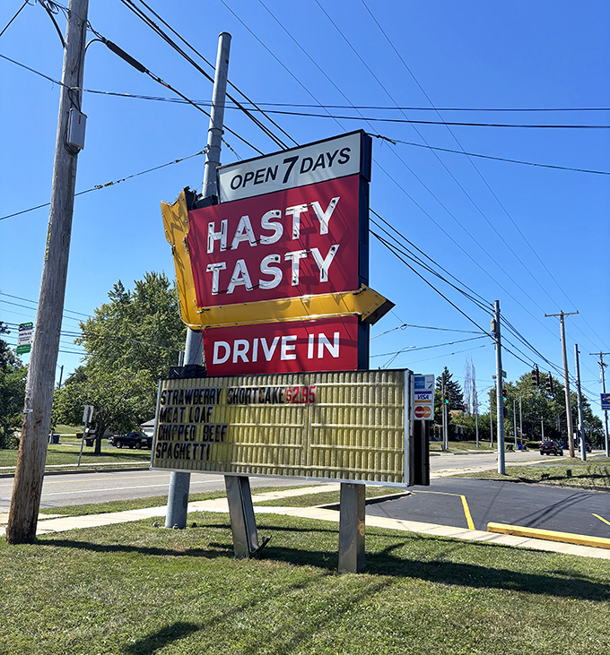 The roadside sign stands tall like a nostalgic lighthouse, guiding hungry travelers to a shore where breakfast is served all day and nobody rushes you out.