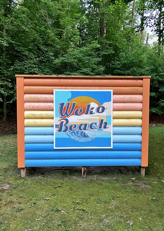 The colorful welcome sign promises exactly what it delivers &ndash; a beach experience that feels like a warm hug from Michigan itself.