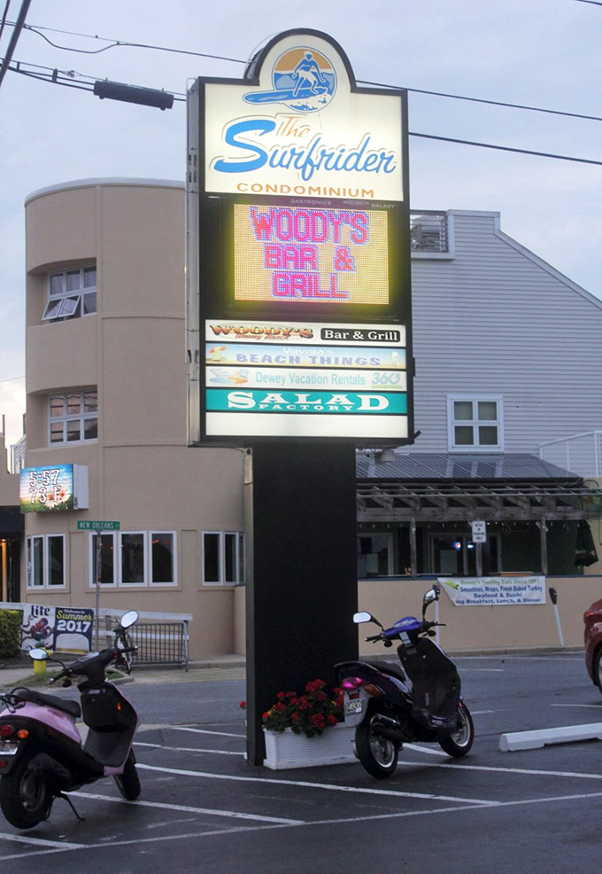 The illuminated sign glows like a lighthouse for the hungry, guiding seafood pilgrims to their delicious destination after sunset.