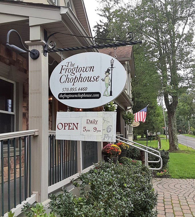 The whimsical frog in top hat sign welcomes hungry travelers, promising fine dining with a side of Pocono charm.