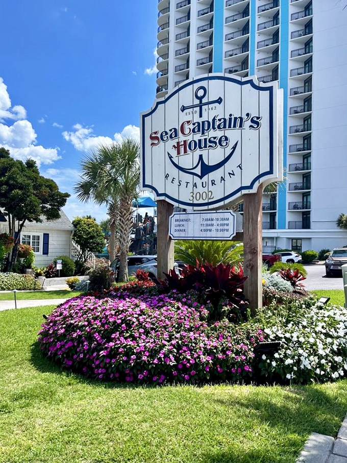 The Sea Captain's House sign stands as a beacon among the flowers&mdash;a colorful landmark announcing that yes, this little cottage among the towers is indeed a restaurant worth finding.