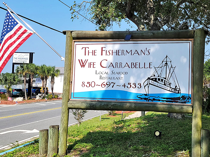 The roadside sign stands like a beacon of hope for hungry travelers. When you see that fishing boat logo, you know you've found the real Florida.